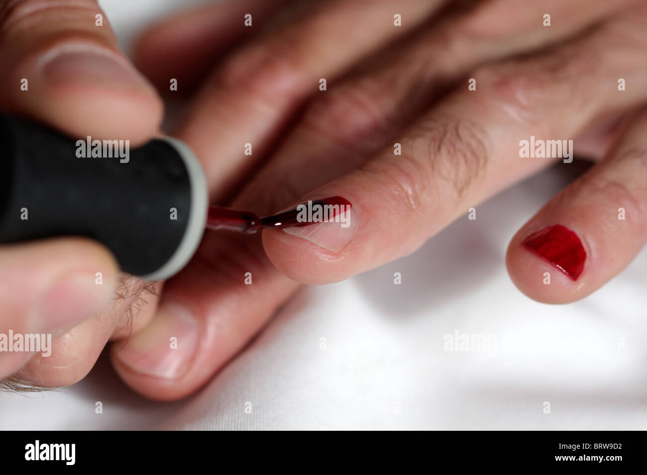 Man painting finger nails hi-res stock photography and images - Alamy