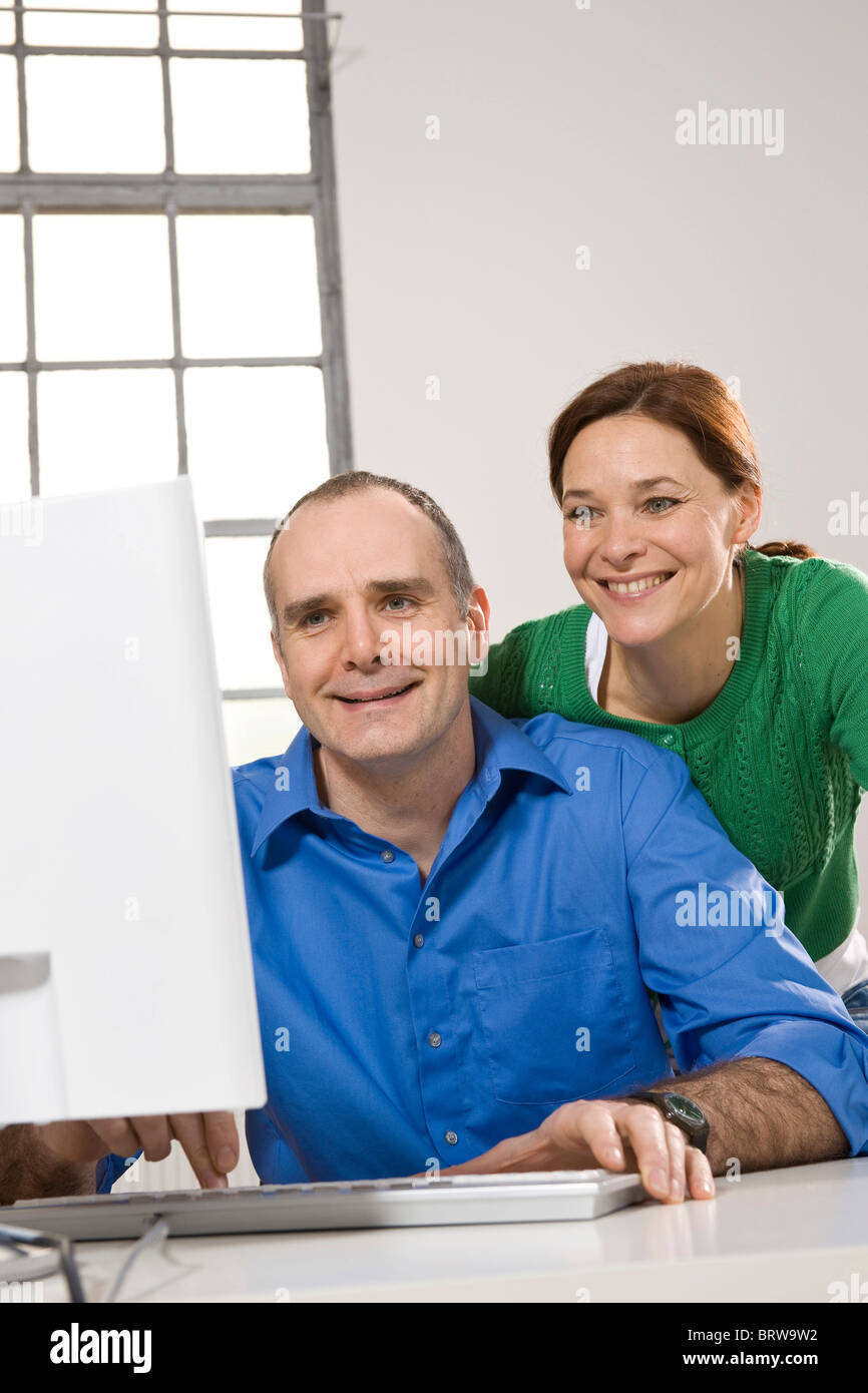Woman and man together at a computer Stock Photo - Alamy