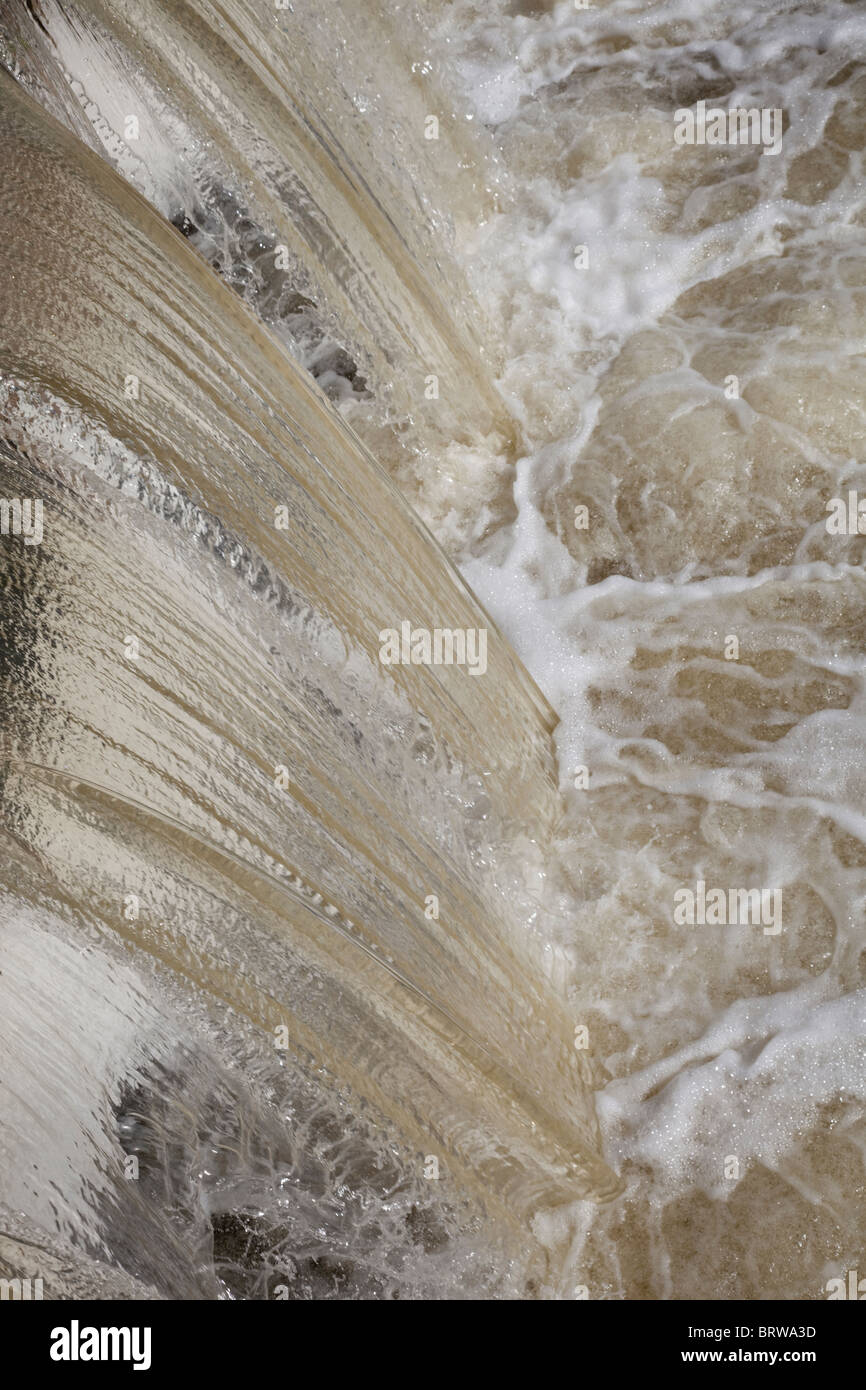 Water falling over waterfall aerating river Tewkesbury Gloucestershire ...