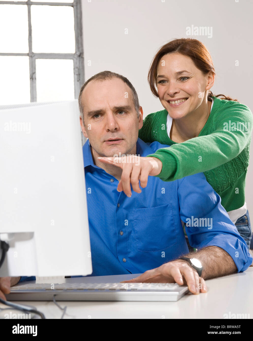 Woman and man together at a computer Stock Photo - Alamy