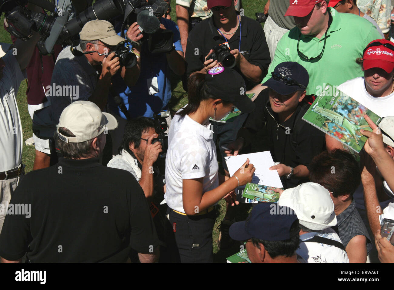 Fifteen year old child golf star Michelle Wie is signing autographs for ...