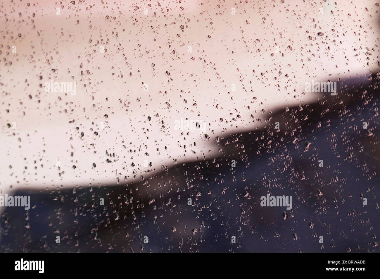 Raindrops on a window pane with reflection of a row of houses Stock ...