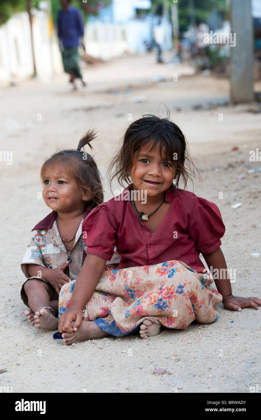 Young poor lower caste Indian street girl and her baby brother sitting ...