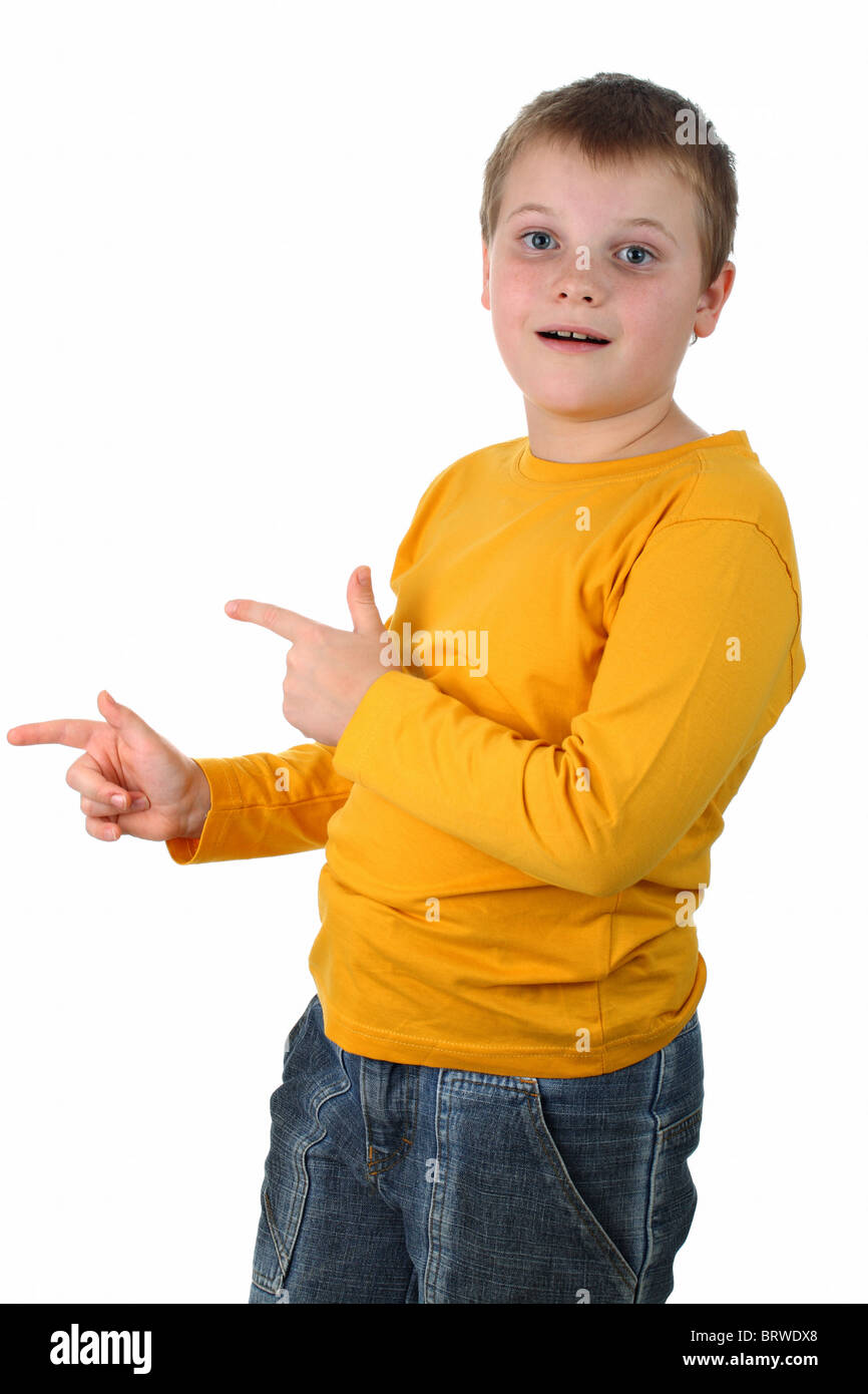 Delighted young boy points his finger on something isolated on white ...