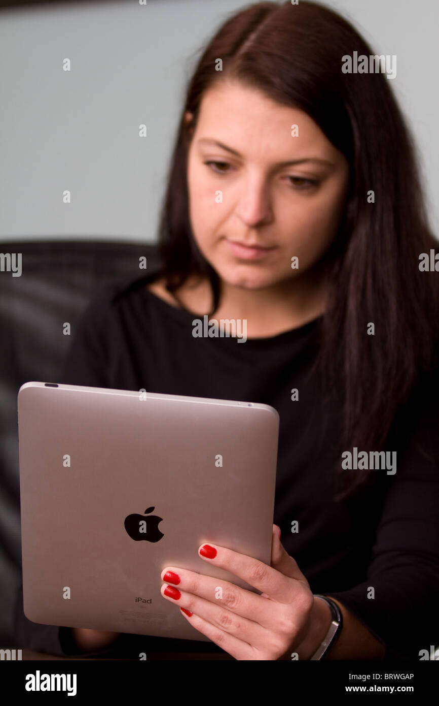 Young woman reading from the Apple iPad Stock Photo - Alamy