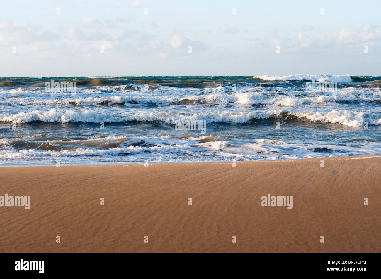 Waves on sandy sea beach hi-res stock photography and images - Alamy