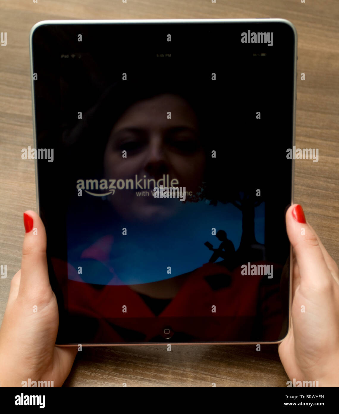 Woman's hands holding an Apple iPad with her reflection in the Amazon ...