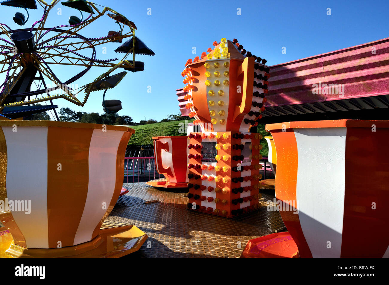 The brilliant colours of the children's tea cup ride dazzle in the ...