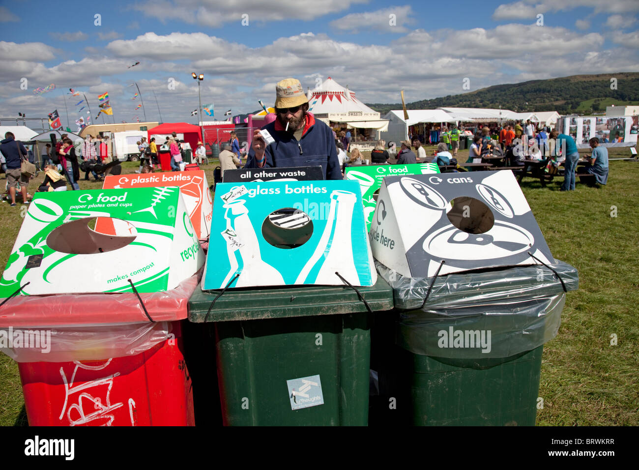 Man recycling at range of colourful recycling bins Greenbelt Festival ...