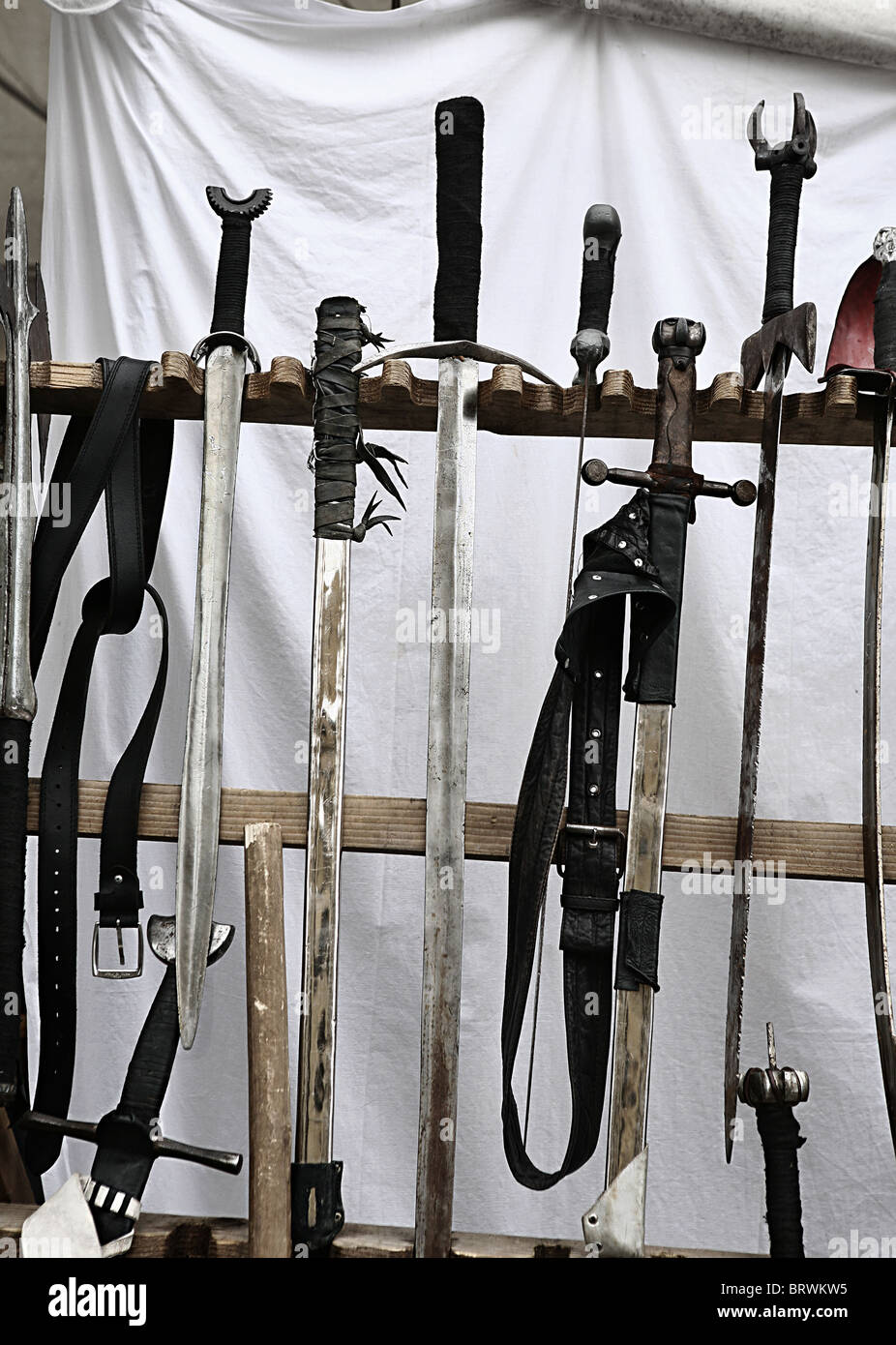 Different swords and belts on outdoor display Stock Photo - Alamy