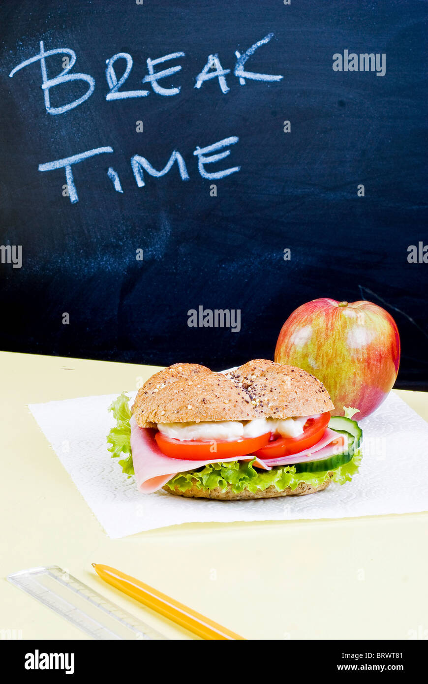 Sandwich and apple on classroom table - breakfast Stock Photo - Alamy