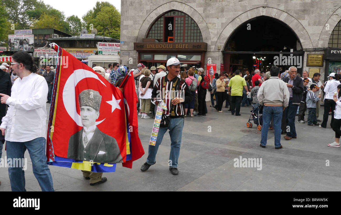 TURKEY Crowd near the Yeni Mosque, Istanbul. Man selling Turkish flags ...
