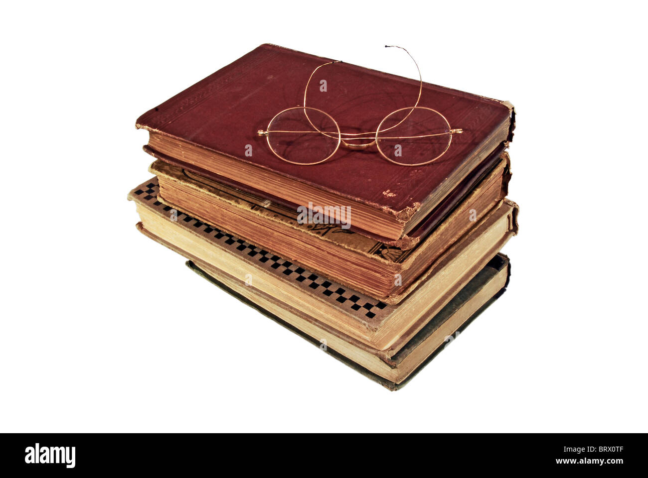 Gold framed spectacles on a stack of old books Stock Photo - Alamy
