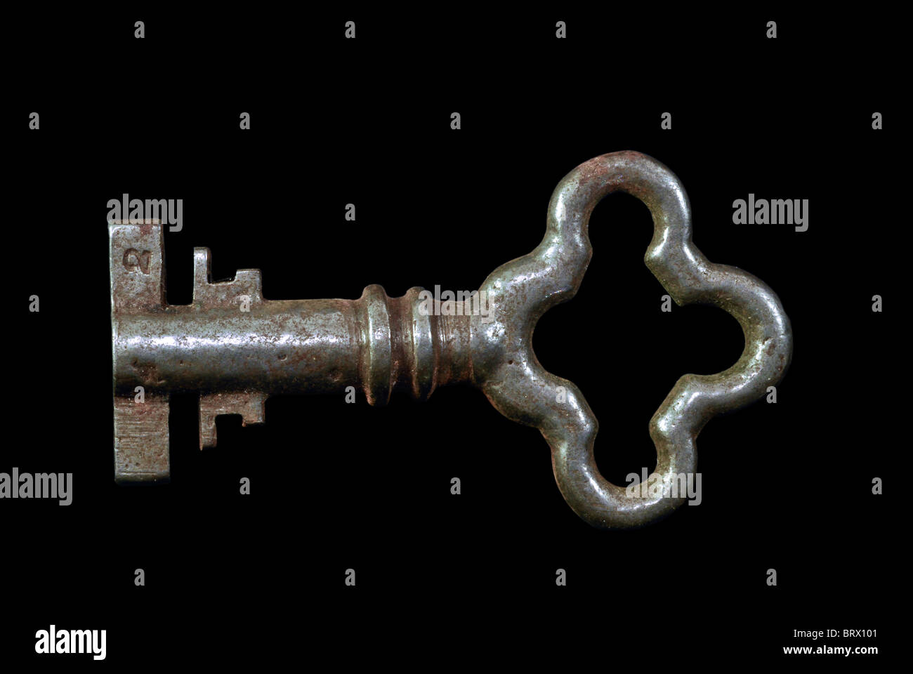 A small metal key against black Stock Photo - Alamy