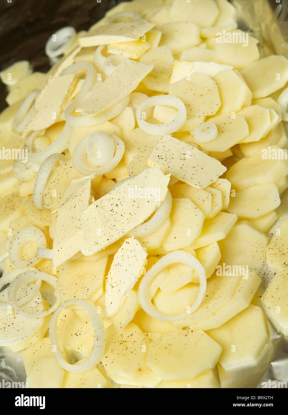 cut and prepared uncooked potatos and onions ready to grill Stock Photo ...