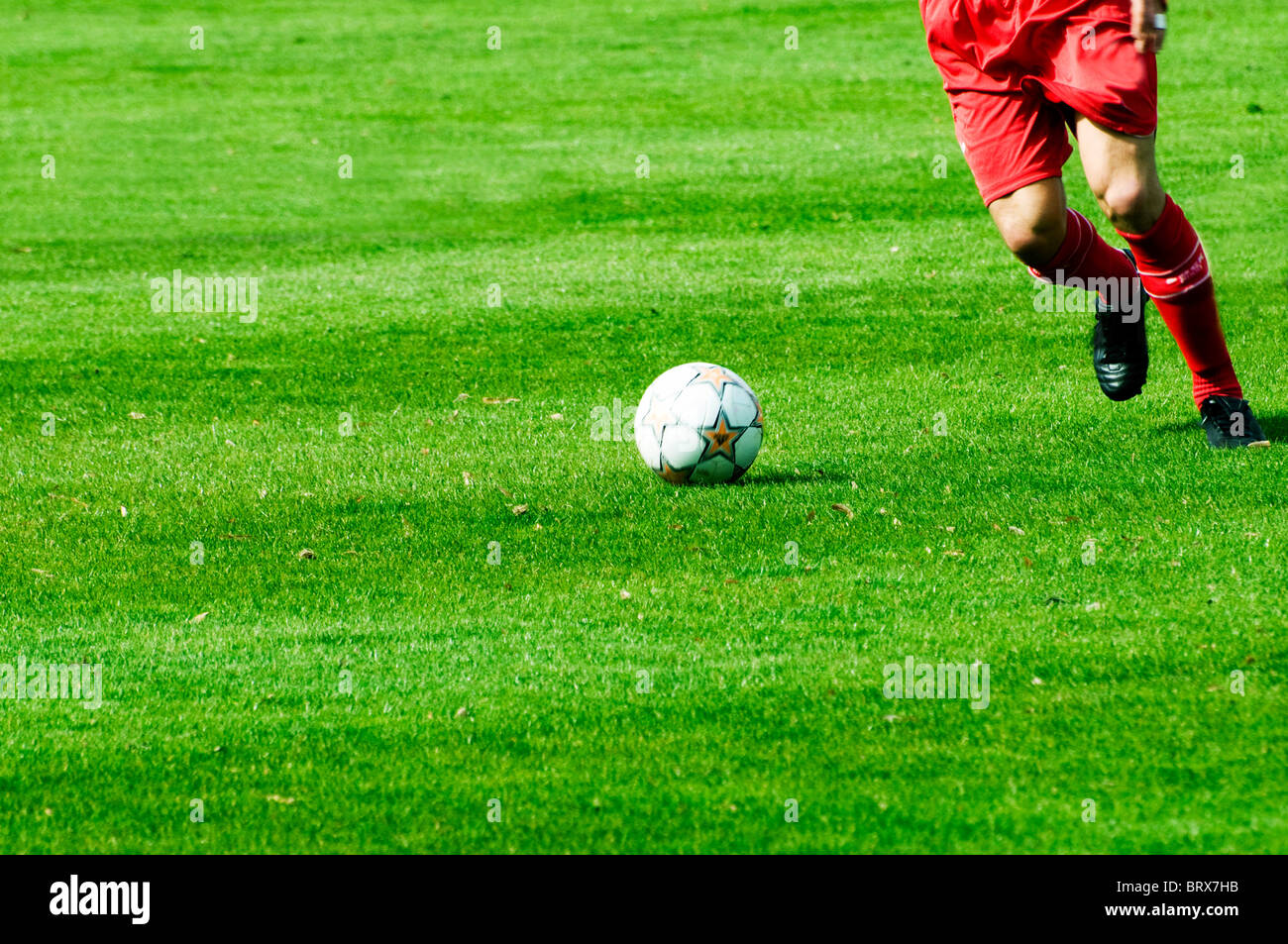 soccer players legs during a match of football, with copy space Stock ...