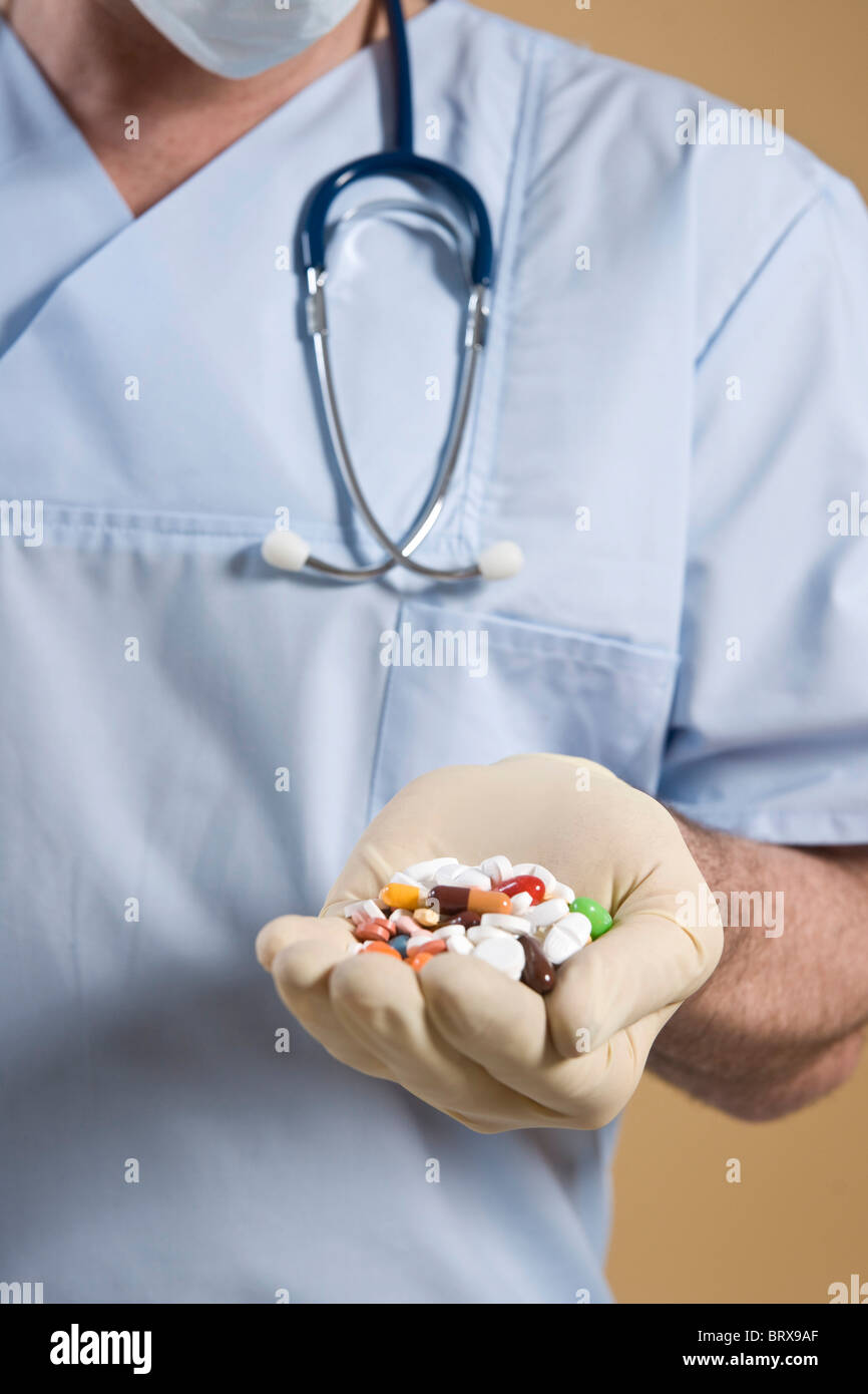 Doctor holding a large number of tablets in his hand Stock Photo - Alamy