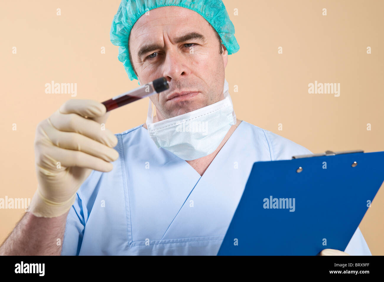 Portrait of a surgeon checking a blood sample test tube Stock Photo - Alamy