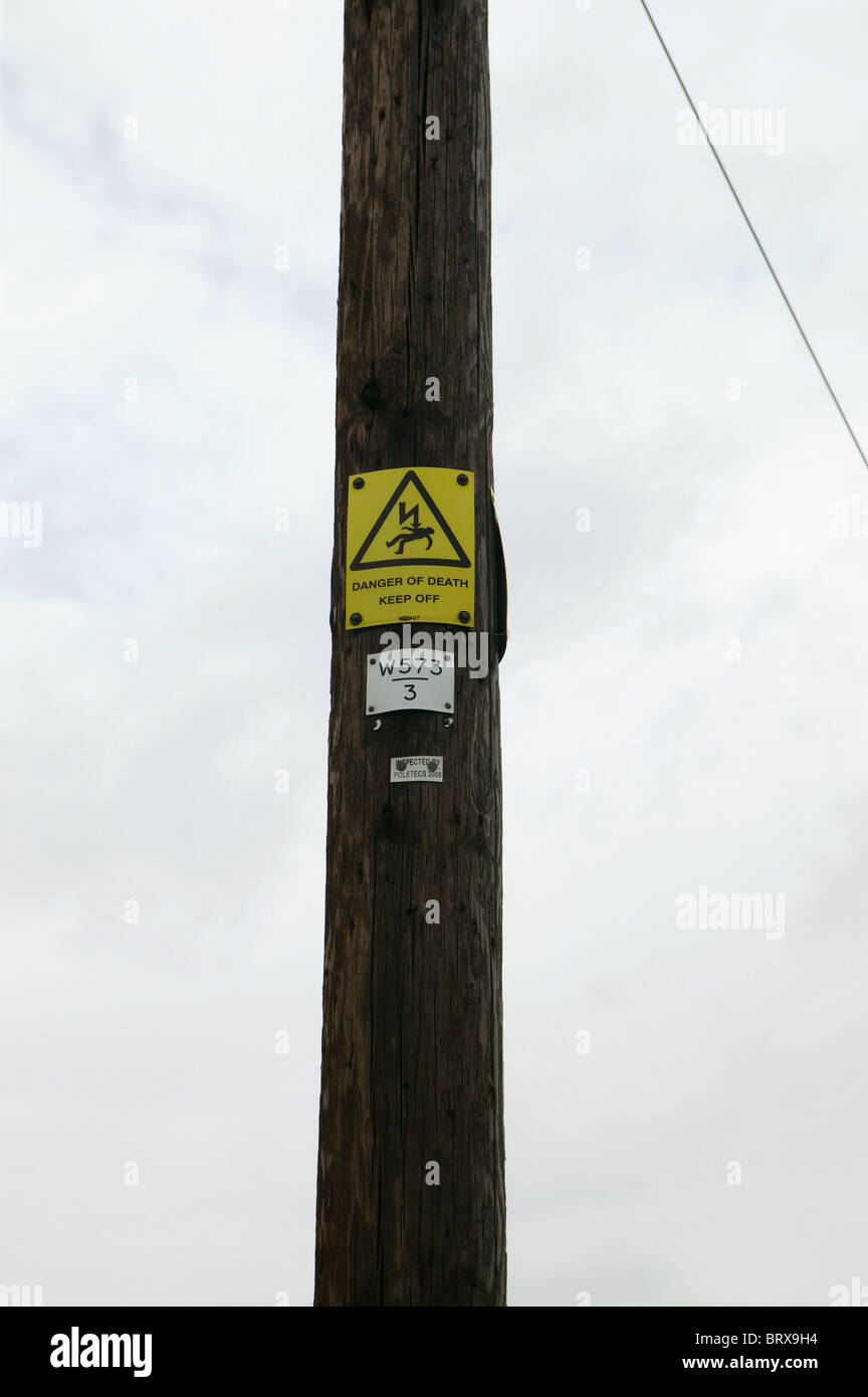 telegraph pole with danger of death sign attached Stock Photo - Alamy