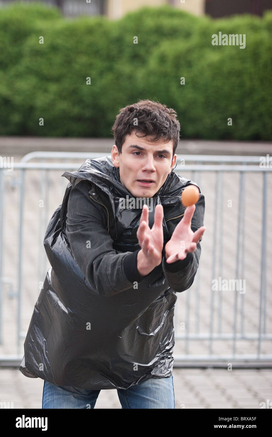 Man catching an egg. Competition Stock Photo - Alamy