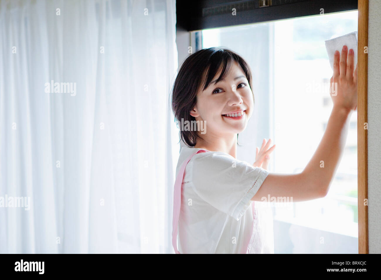 Young Woman Cleaning Windows Stock Photo - Alamy