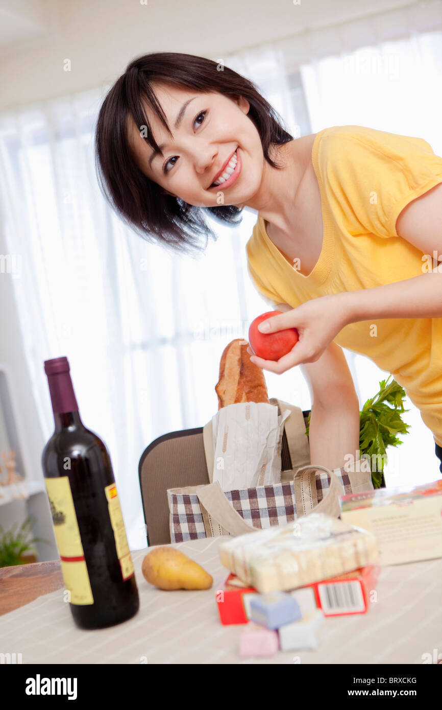 Woman Sorting Out Grocery Shopping Stock Photo - Alamy