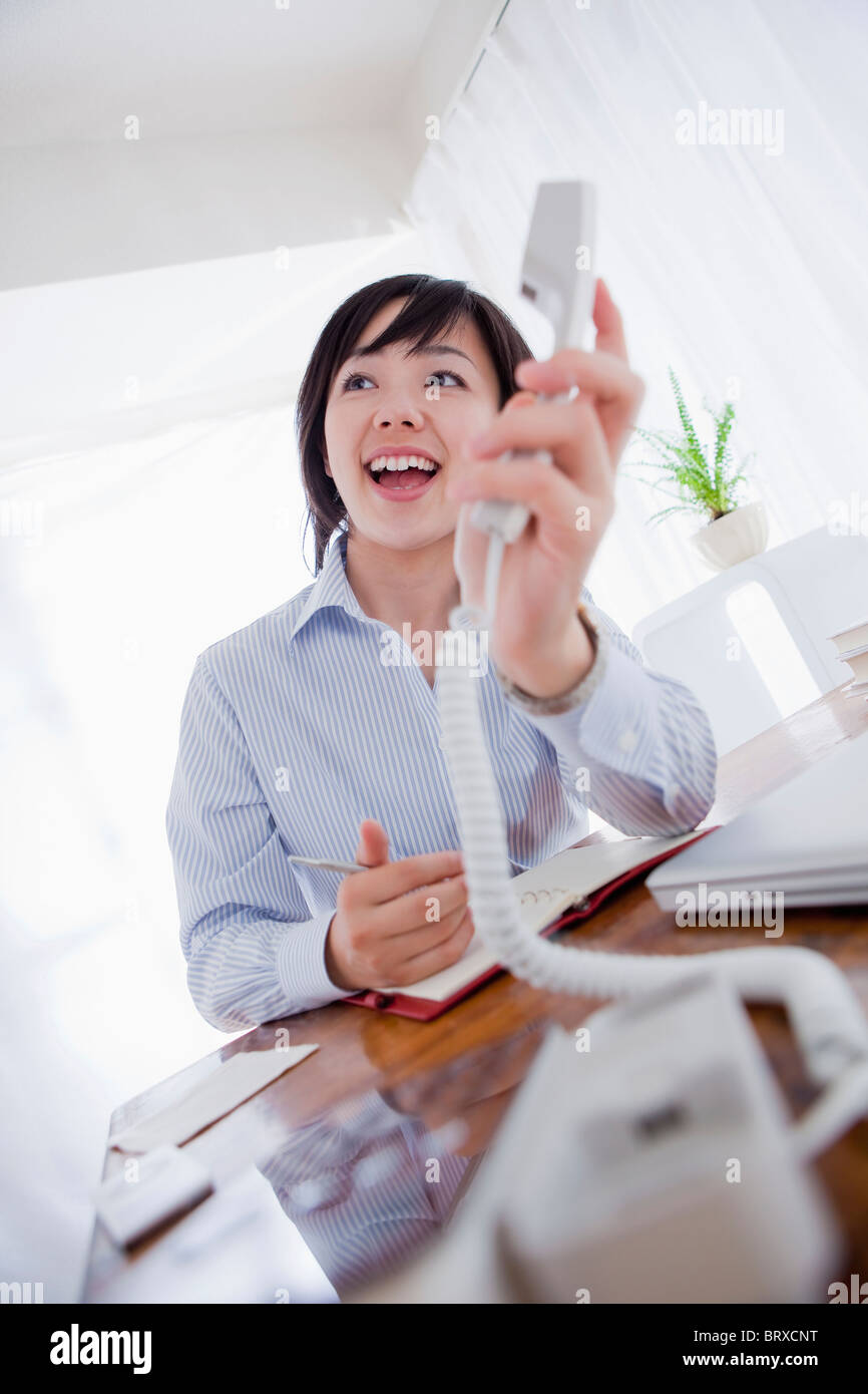 Businessman Taking a Call for a Colleague Stock Photo - Alamy