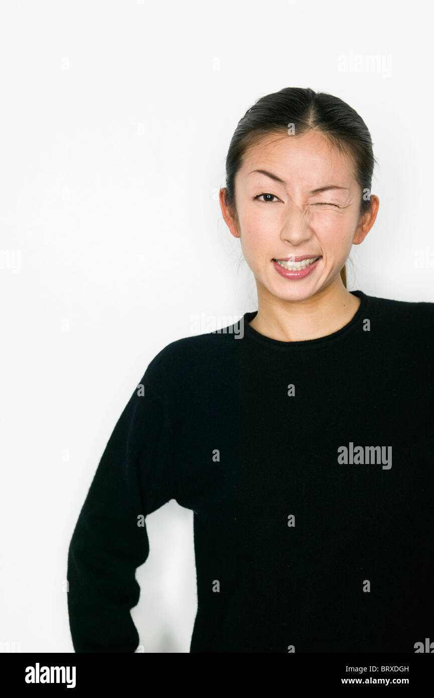 Young Woman Winking Stock Photo - Alamy