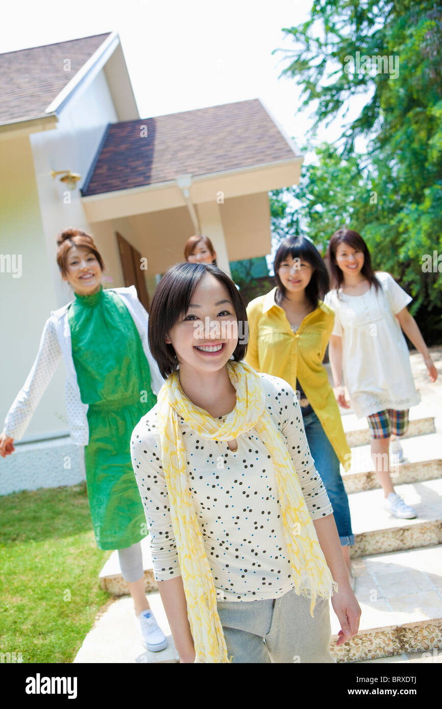Five Young Women Walking Down Steps Stock Photo - Alamy