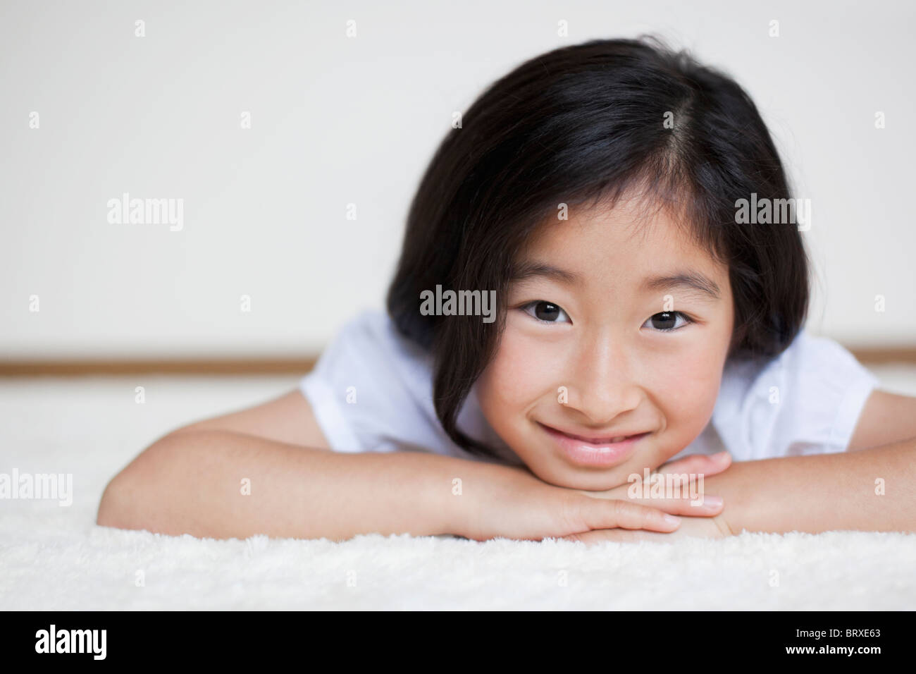 Portrait of Young Girl Lying on her Front Stock Photo - Alamy