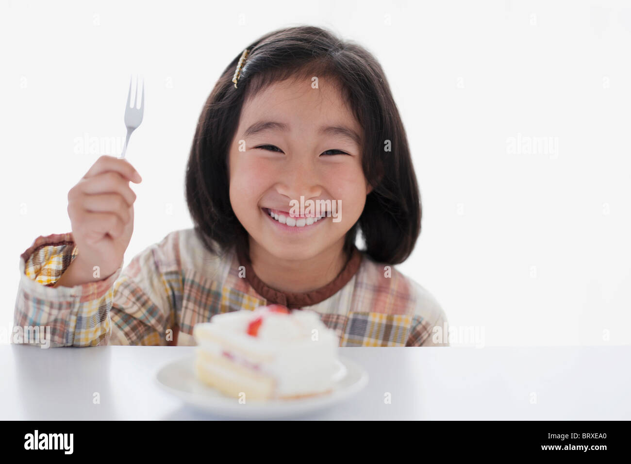 Young Girl Eating Cake Stock Photo - Alamy