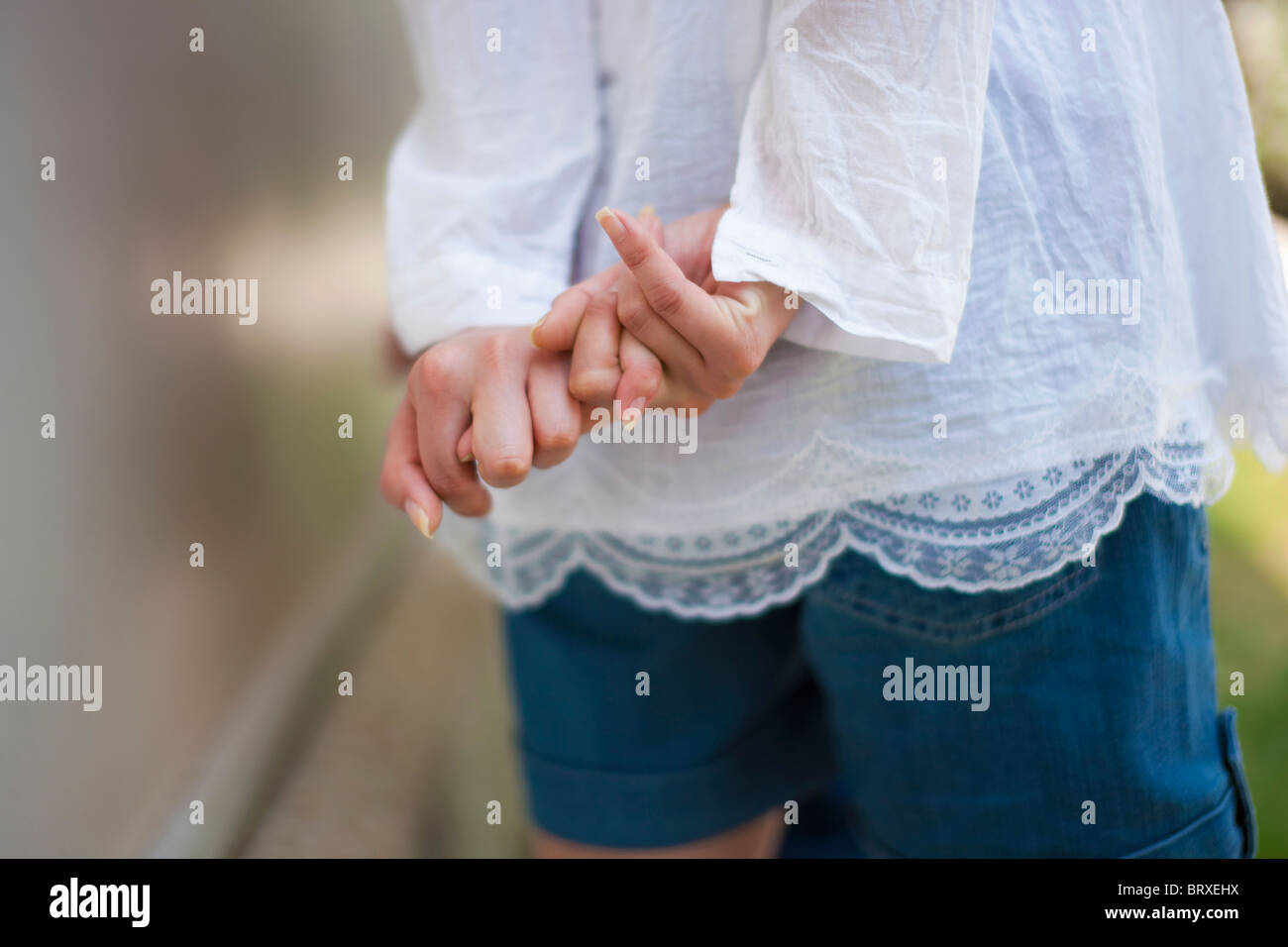 One hand behind back hi-res stock photography and images - Alamy
