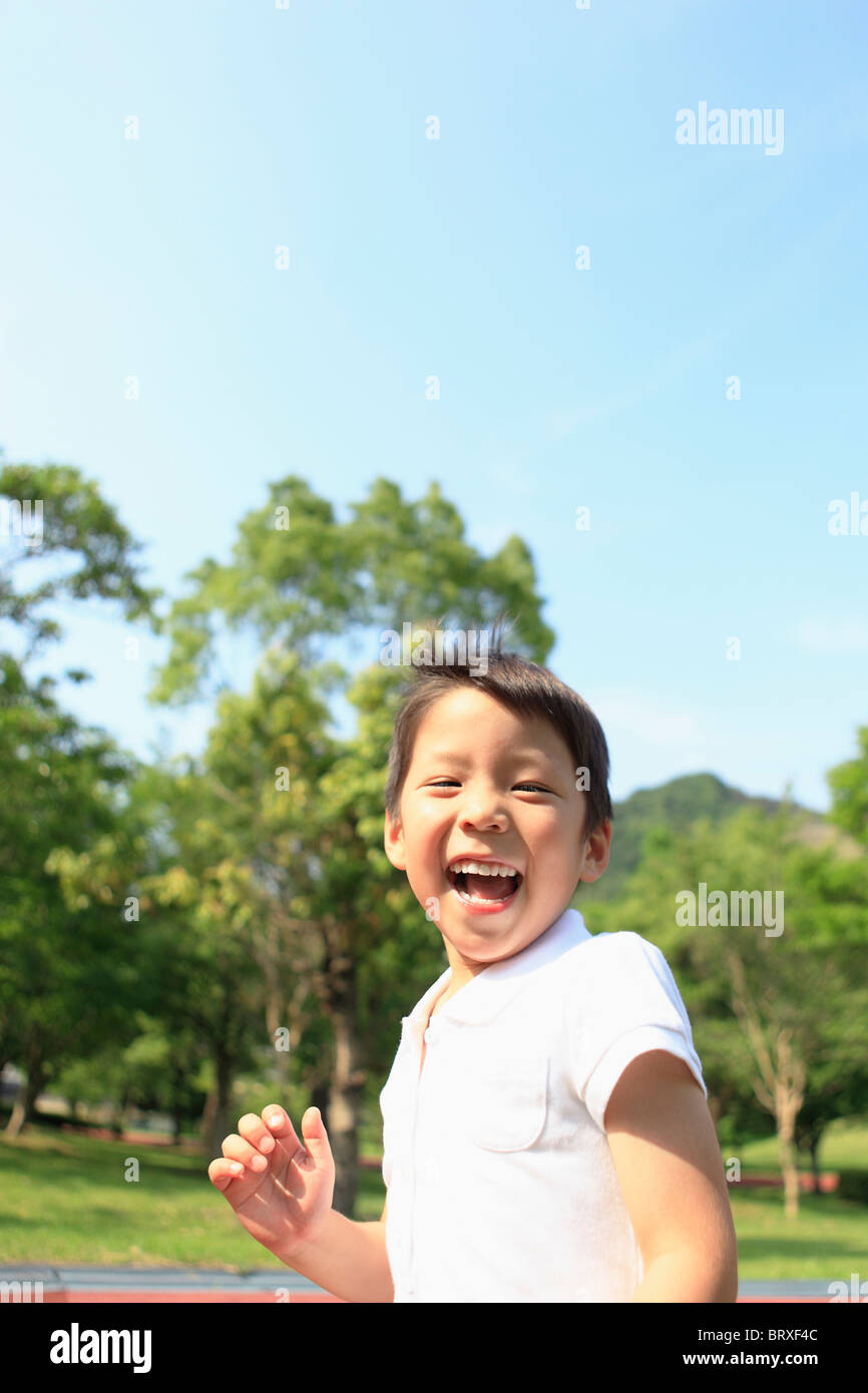 Young Boy Laughing in Park Stock Photo - Alamy