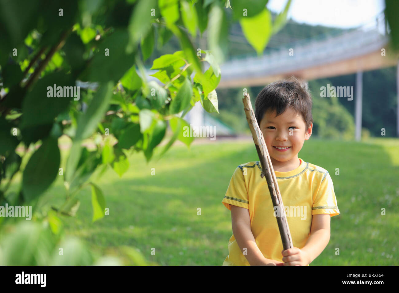 Young Boy With a Stick Stock Photo - Alamy