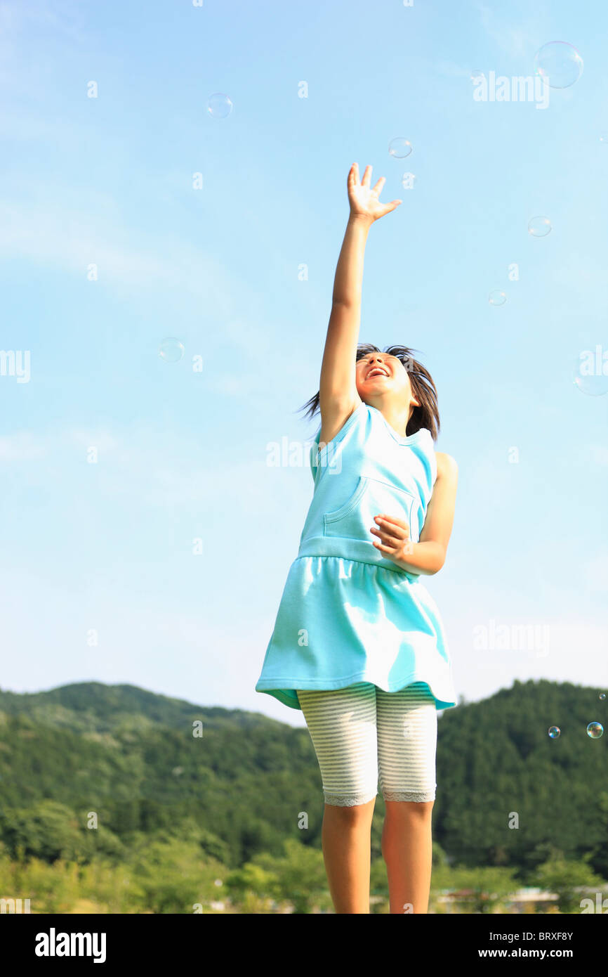 Girl Reaching Up To The Sky