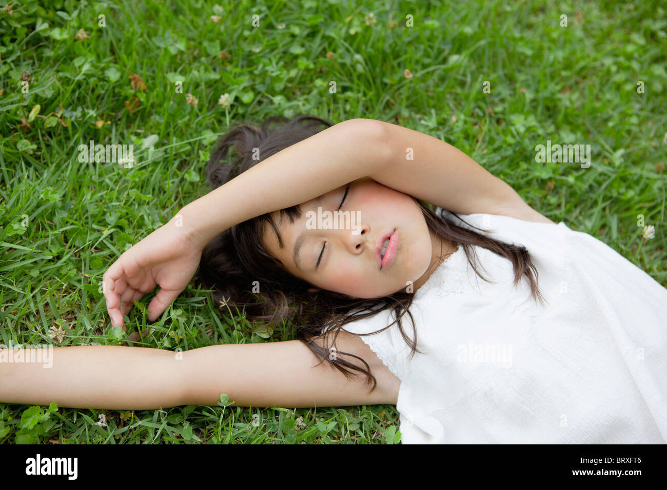 Girl Sleeping on Grass Stock Photo - Alamy