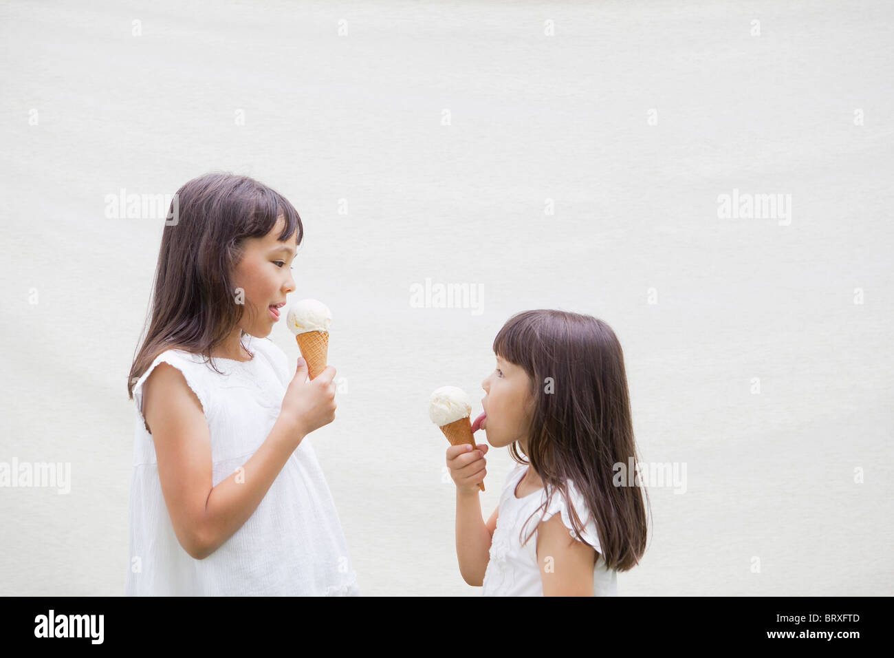 Side view two girls licking hi-res stock photography and images - Alamy