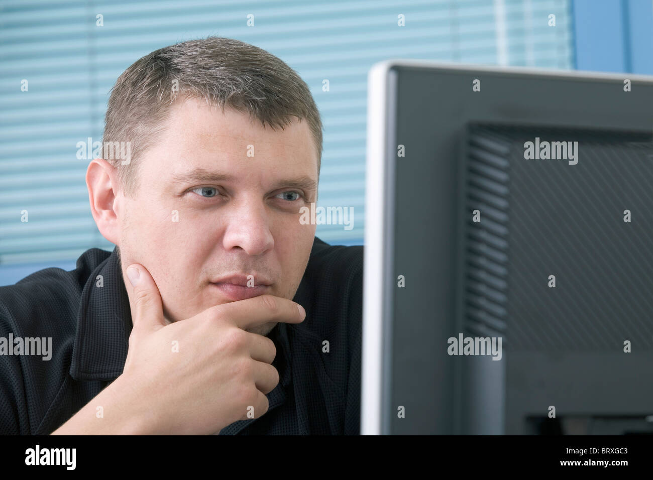 Mid adult man using computer Stock Photo - Alamy