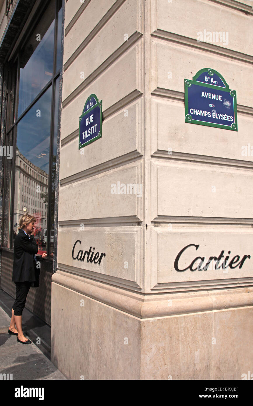 WOMAN IN FRONT OF THE DISPLAY WINDOW OF THE CARTIER LUXURY JEWELRY SHOP ...