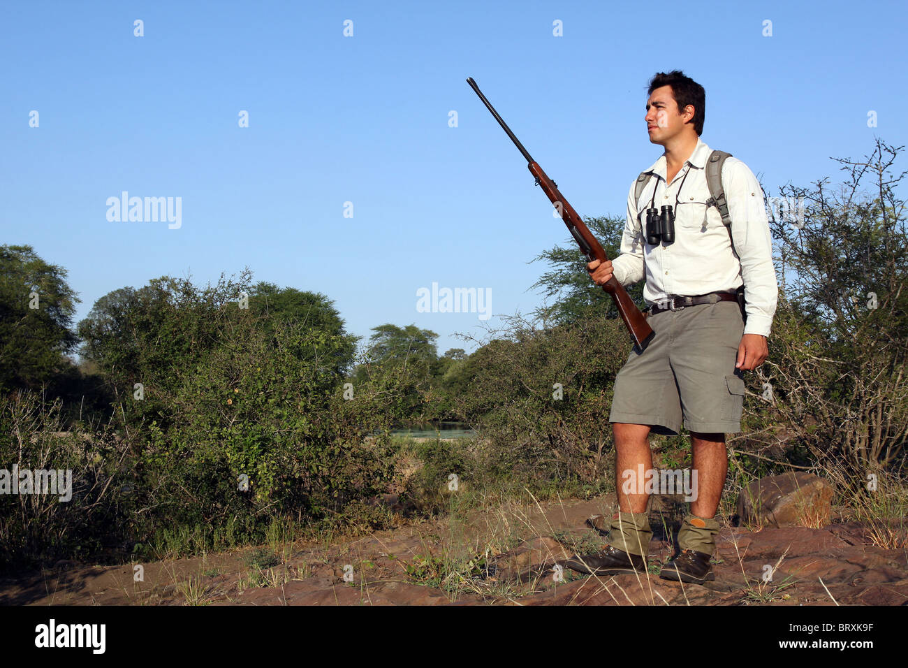 SOUTH AFRICAN RANGER POSING WITH HIS RIFLE, SINGITA LEBOMBO LODGE ...