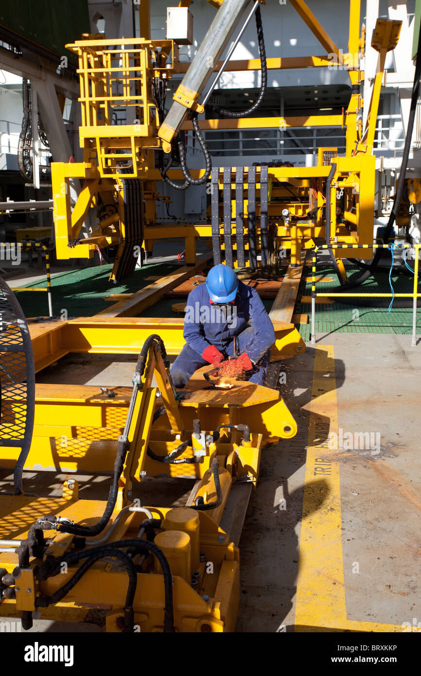 Welder working on operations deck of "Sarah" deep water well ...