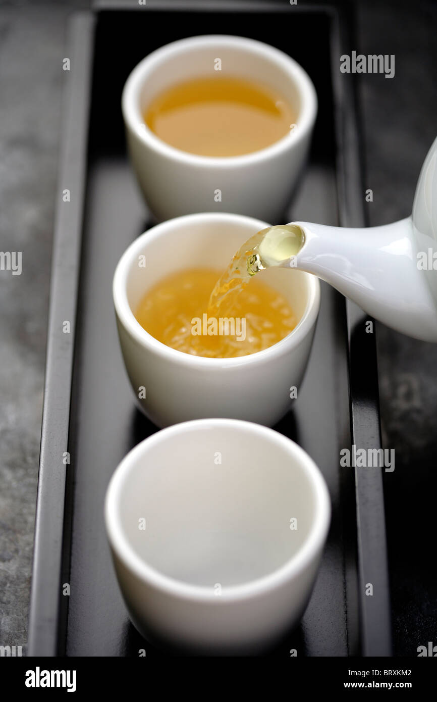 Tea being poured into a tea cup hi-res stock photography and images - Alamy