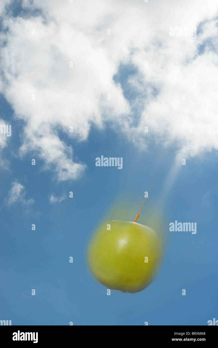 Apple falling out of sky Stock Photo - Alamy