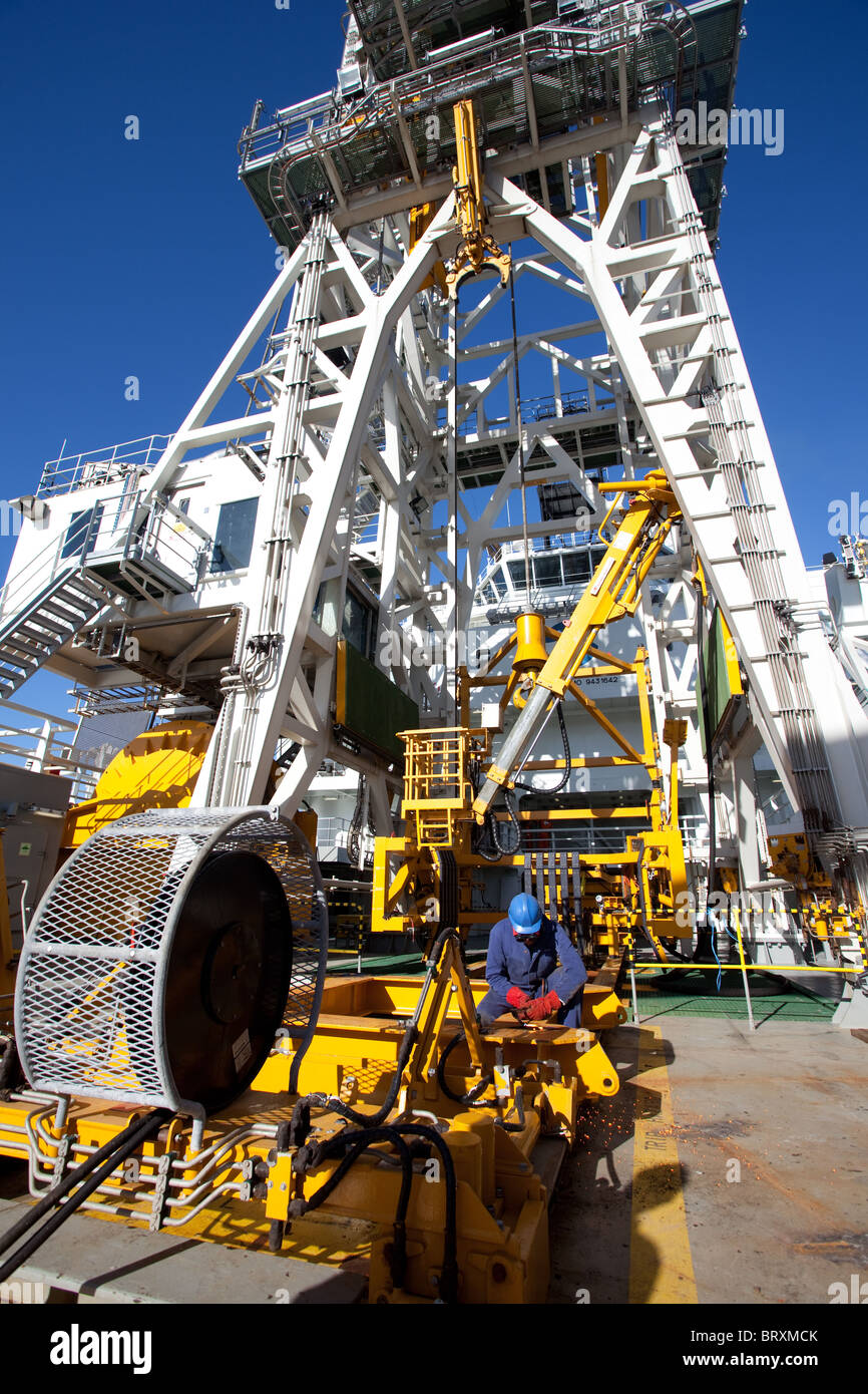 Welder working on operations deck of "Sarah" deep water well ...