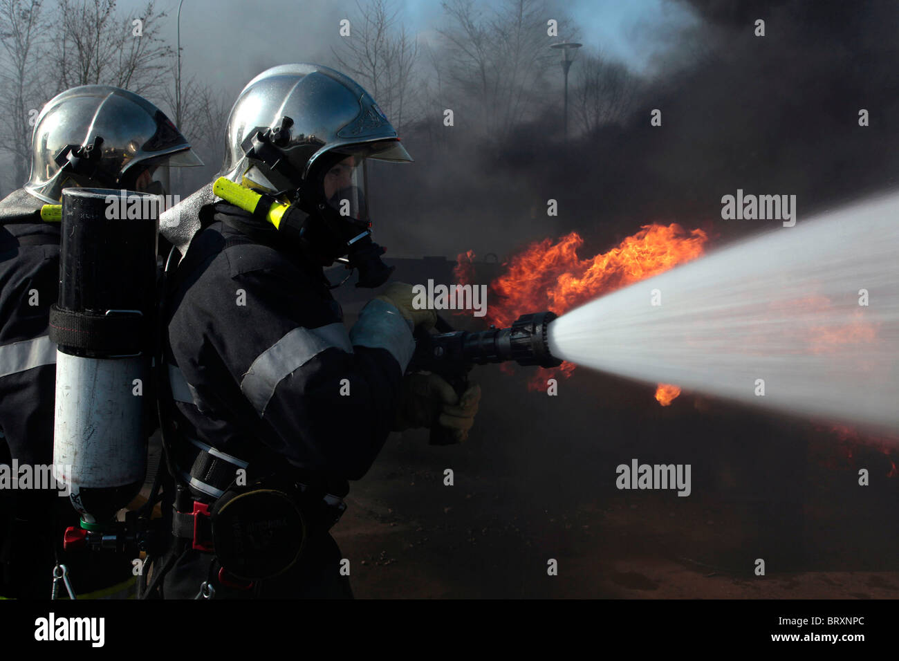 FIREFIGHTERS BATTLING A HYDROCARBON FIRE, DEPARTMENTAL FIREFIGHTERS ...