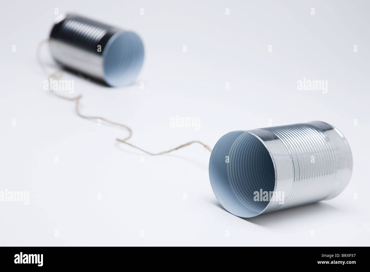 Tin can phone on white background Stock Photo - Alamy