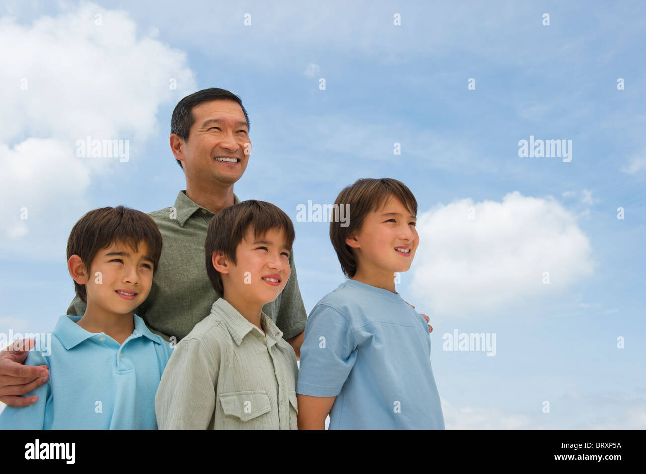 Smiling father and sons Stock Photo - Alamy