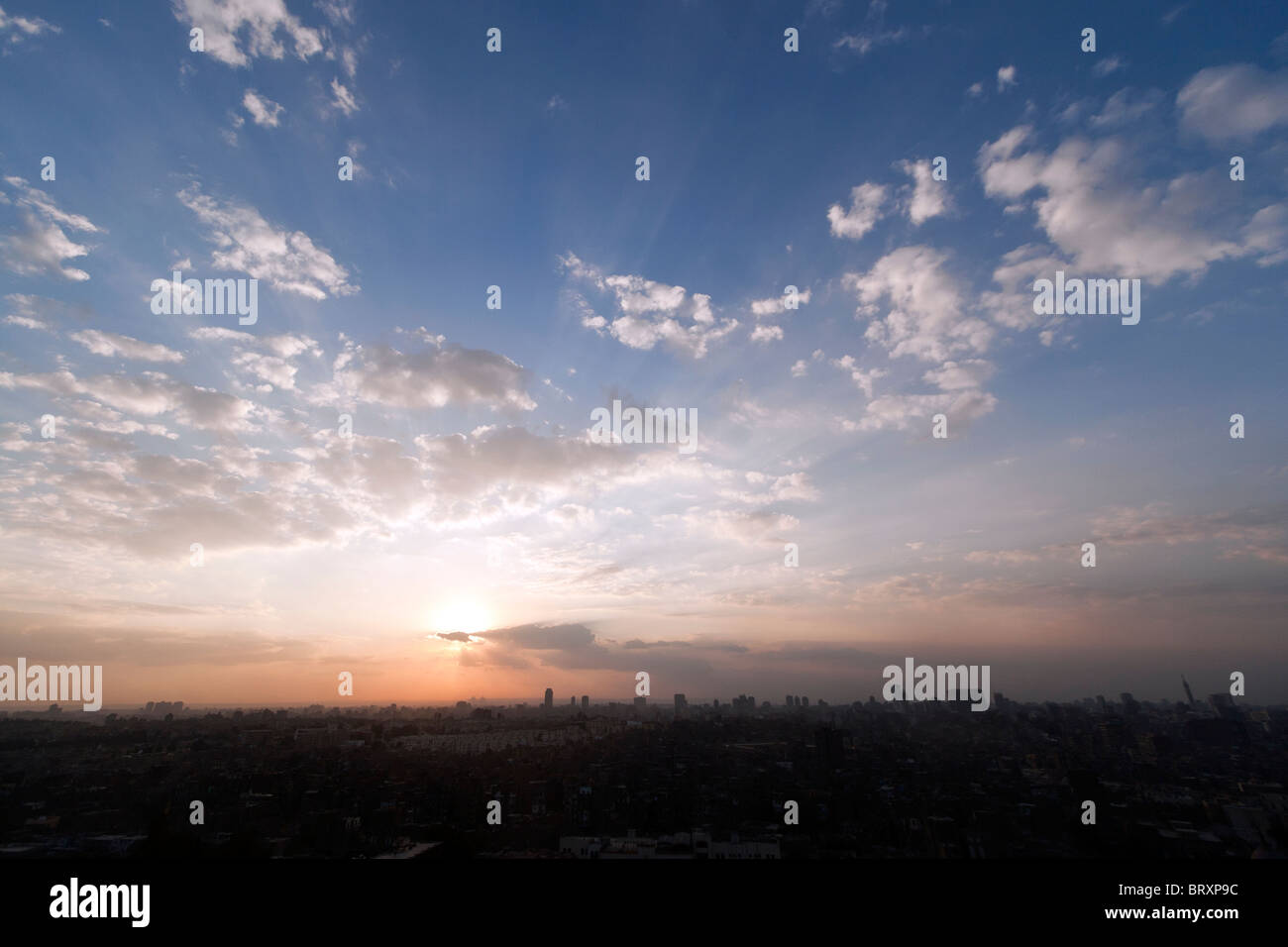 Sunset over Cairo with an outline of the Great Pyramids on the horizon ...