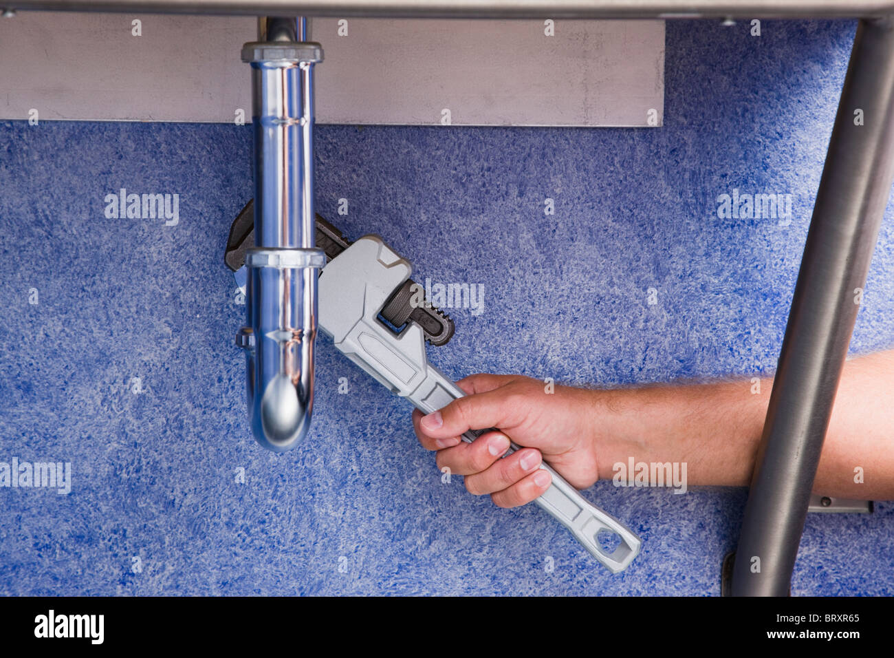 Man repairing pipe with wrench, close-up Stock Photo - Alamy