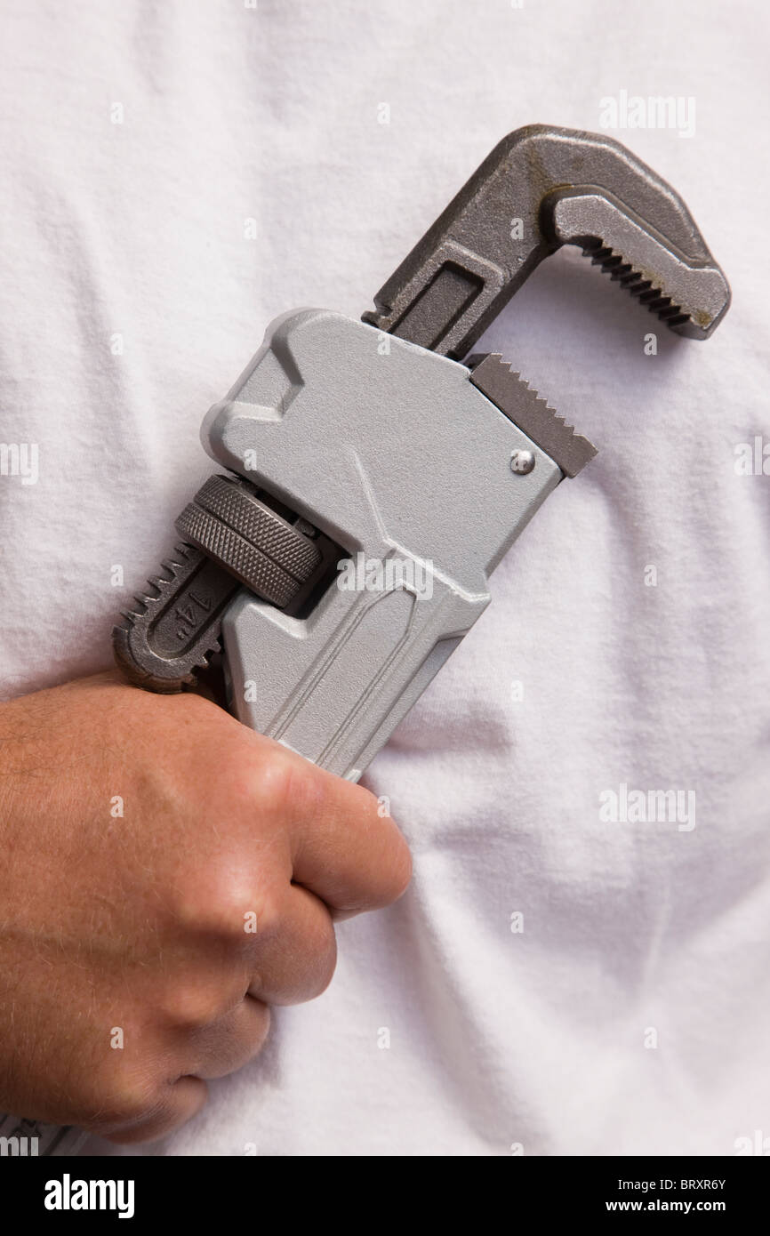 Man holding wrench, close-up of hand Stock Photo - Alamy